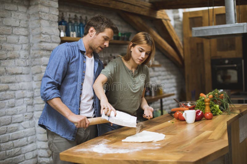 Young Couple Making Pizza in Rustic Kitchen Together Stock Image ...
