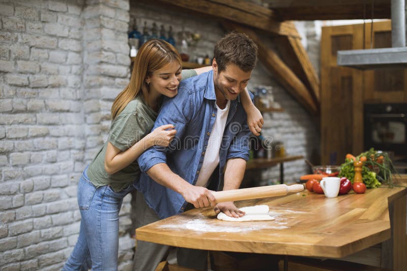Young Couple Making Pizza in Rustic Kitchen Together Stock Image ...