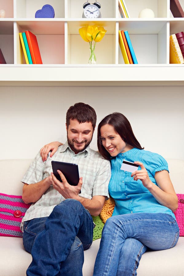 Couple Making Purchases on the Internet Stock Image - Image of couch ...