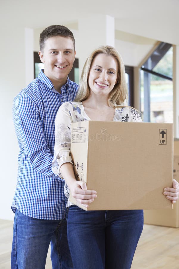 Young Couple Moving into New Home Together Stock Photo - Image of ...