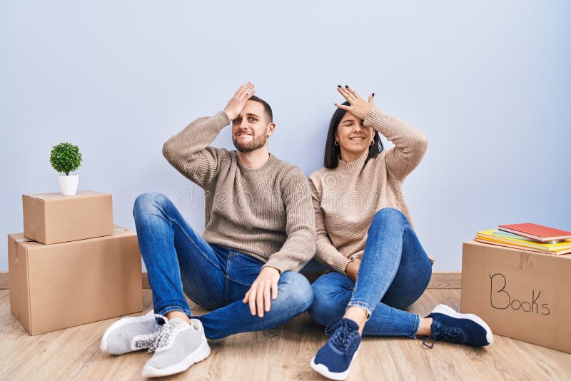 Young Couple Moving To a New Home Surprised with Hand on Head for ...