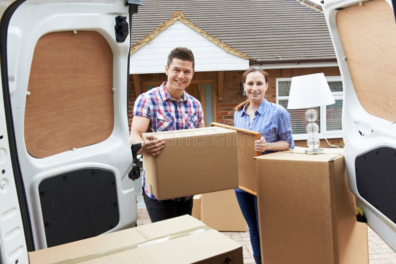 Young Couple Moving in To New Home Unloading Removal Van Stock Photo ...