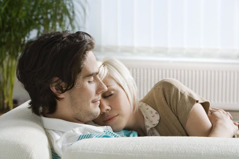 Young Couple Napping on Sofa Embraced Close-up Stock Photo - Image of ...