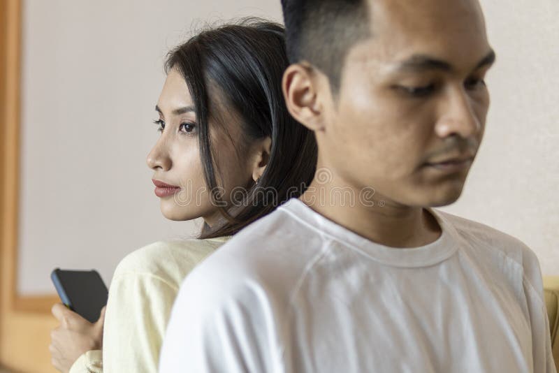 Young Couple Not Talking To Each Other they are Busy Using Smartphone ...