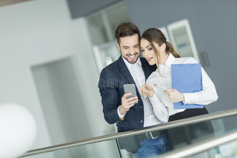 Young couple in the office stock image. Image of phone - 52427087