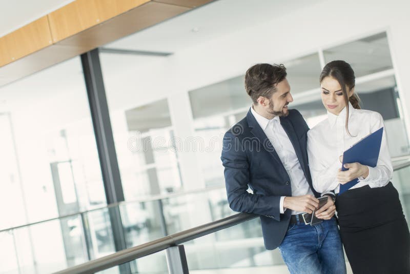 Young couple in the office stock photo. Image of professional - 54952114