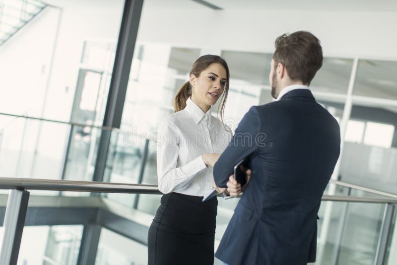 Young couple in the office stock image. Image of working - 55360843