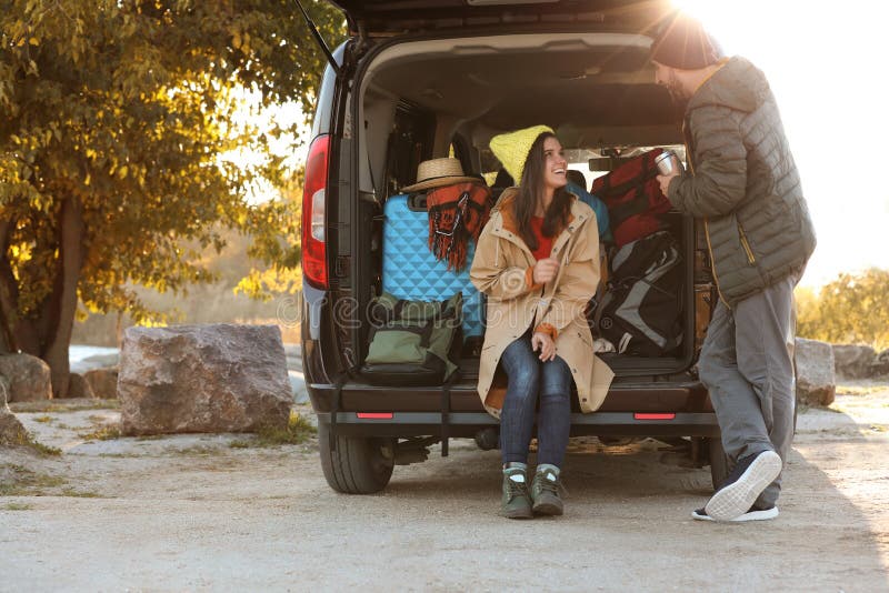Young Couple Packing Camping Equipment into Car Trunk Stock Image ...