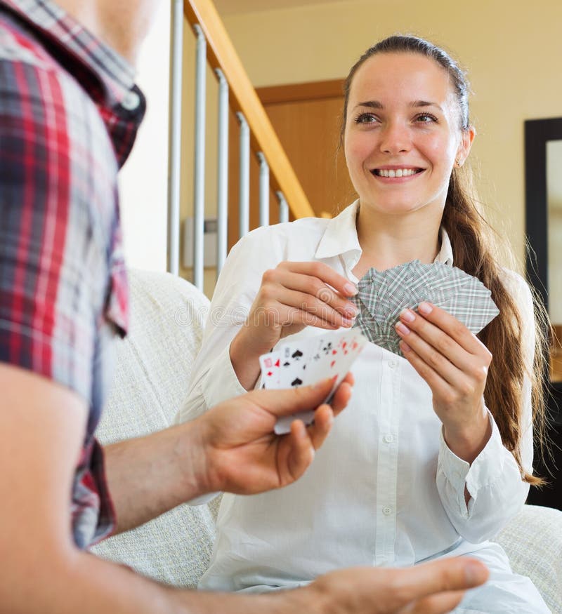 Young couple playing cards stock photo. Image of furniture - 68288054