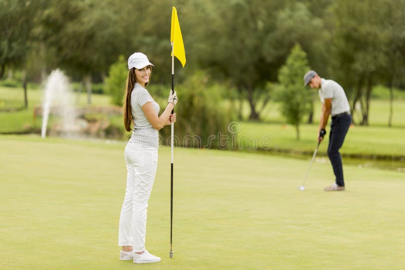 Young couple playing golf stock photo. Image of male - 48308806