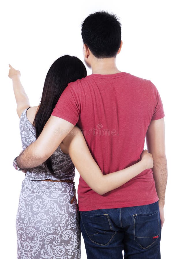 Young Couple Pointing at Copy Space Stock Image - Image of husband ...