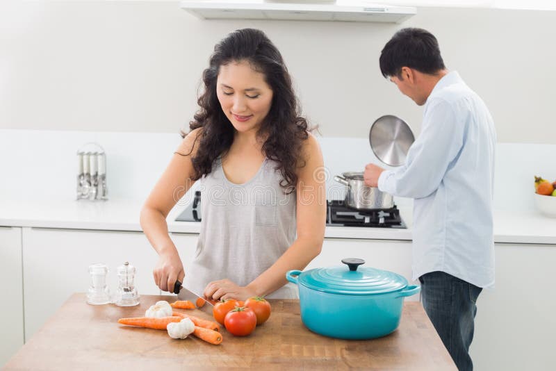 Young Couple Preparing Food Together in Kitchen Stock Image - Image of ...