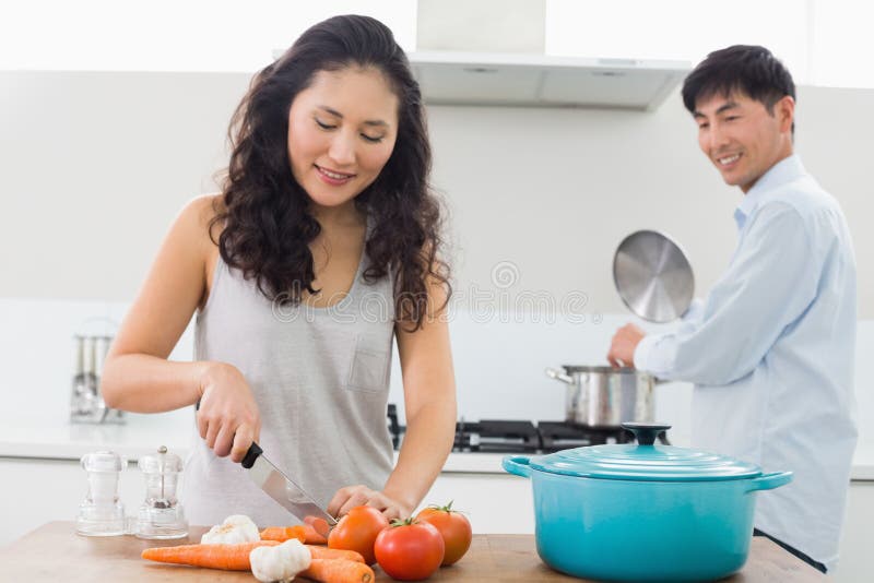 Young Couple Preparing Food Together in Kitchen Stock Image - Image of ...