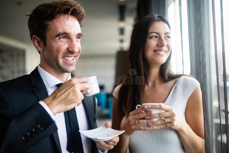 Young Couple of Professionals Chatting during a Coffee Break Stock ...