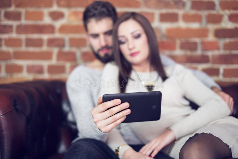 Young Couple Reading Tablet Together Stock Image - Image of couple ...