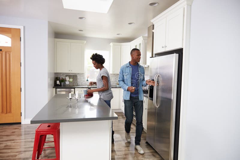 Young Couple Relaxing in Apartment Kitchen Together Stock Photo - Image ...