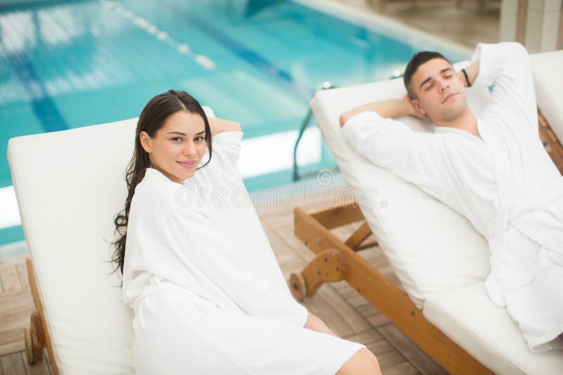 Young Couple Relaxing by Pool Stock Image - Image of leisure, pool ...