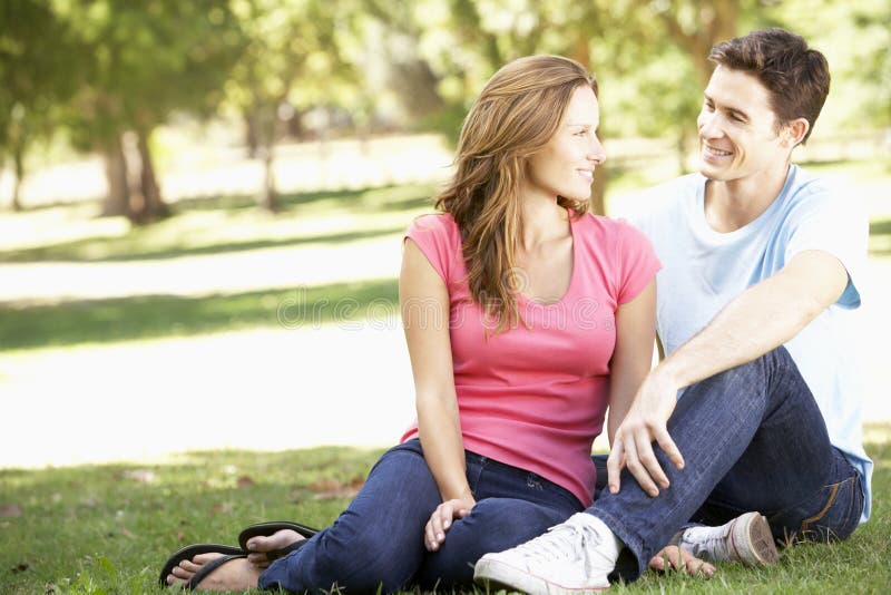Young Couple Relaxing Together in Park Stock Image - Image of lifestyle ...