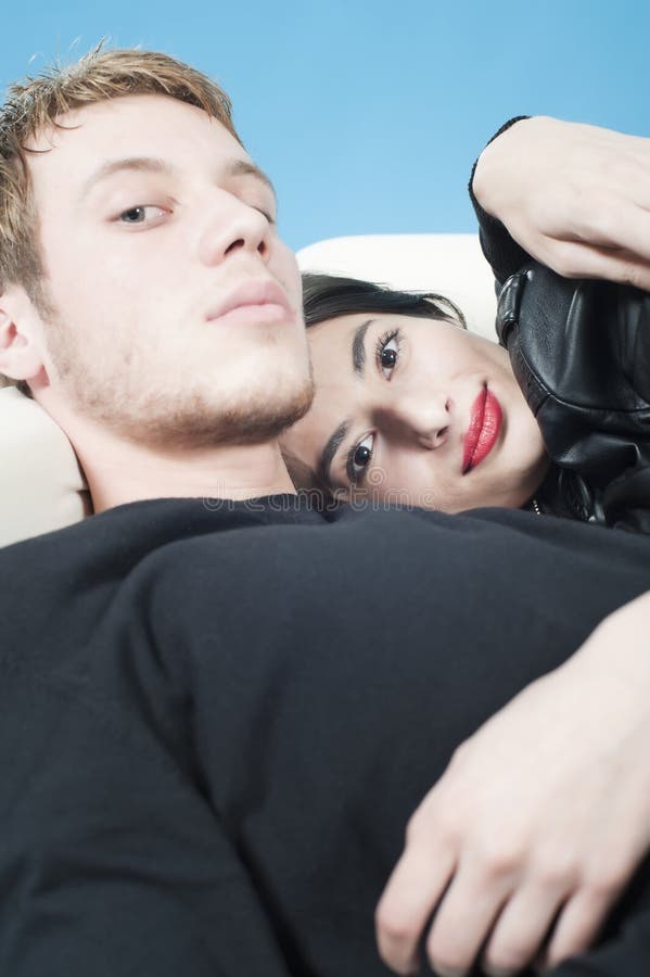 Young Couple Resting on a Sofa Stock Image - Image of adult, room: 17918677