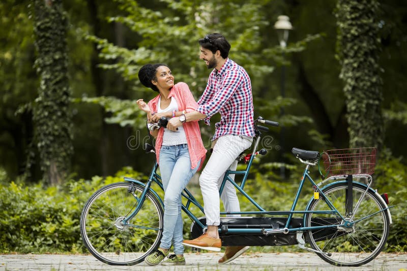 Young Couple Riding on the Tandem Bicycle Stock Photo - Image of female ...