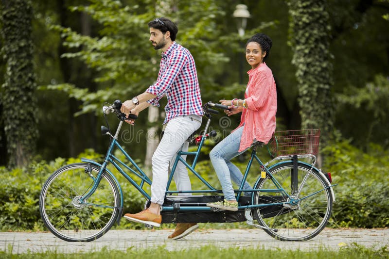 Young Couple Riding on the Tandem Bicycle Stock Image - Image of ...