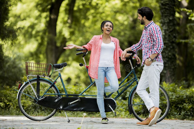 Young Couple Riding on the Tandem Bicycle Stock Photo - Image of nature ...