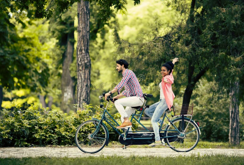 Young Couple Riding on the Tandem Bicycle Stock Photo - Image of ...