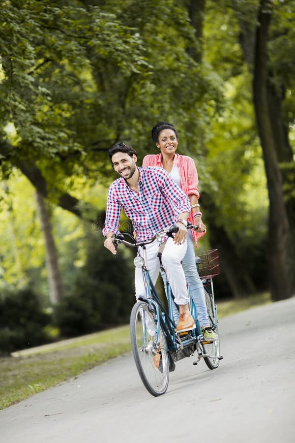 Young Couple Riding on the Tandem Bicycle Stock Photo - Image of ...