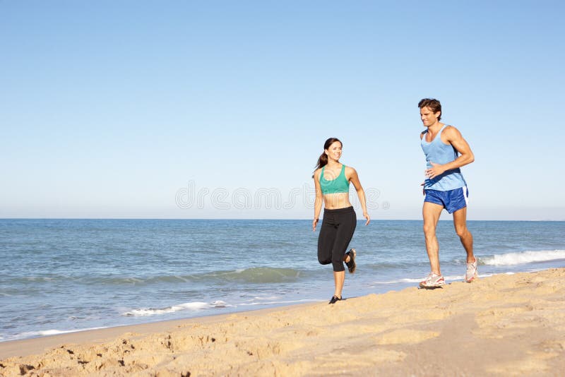 Young Man in Fitness Clothing Running Along Beach Stock Photo - Image ...