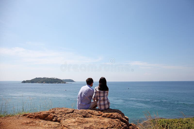 Young couple by the sea stock photo. Image of romance - 65482614