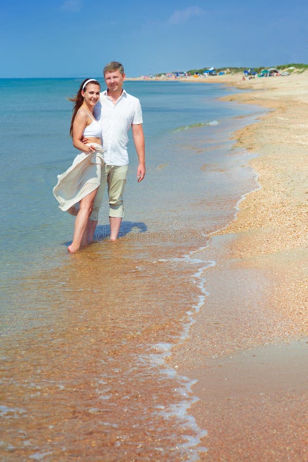 Young couple by the sea stock photo. Image of beach, sunny - 74159978