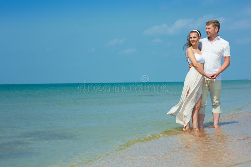 Young couple by the sea stock photo. Image of beautiful - 74159992