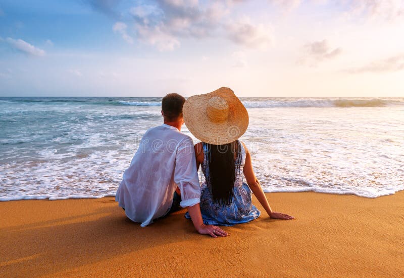 The Couple is Seated on the Ocean Beach Stock Photo - Image of hand ...