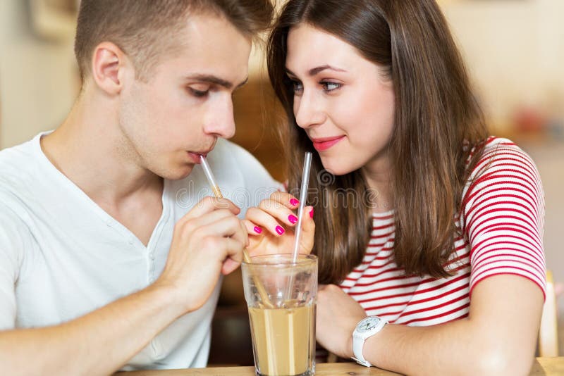 Young Couple Sharing a Drink Stock Image - Image of caucasian, happy ...