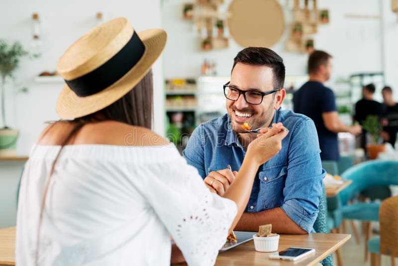 Young Couple Sharing Meal in a Cafe. - Image Stock Image - Image of ...