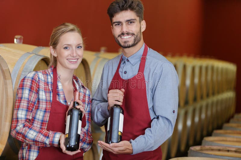 Young Couple Showing Their Bottled Red Wine in Cellar Stock Image ...