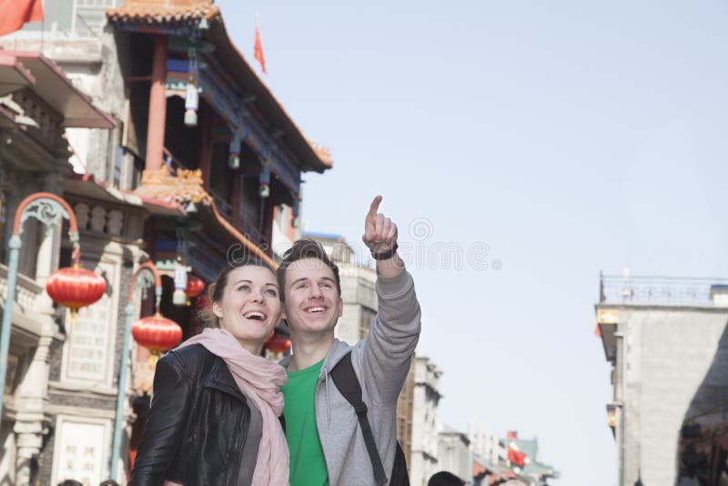Young Couple Sightseeing, Looking and Pointing. Stock Photo - Image of ...