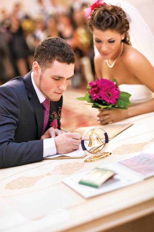 Young Couple Signing Wedding Documents Stock Photo - Image of marriage ...