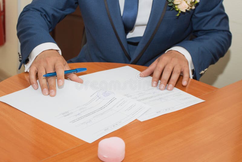 Young Couple Signing Wedding Documents. Stock Image - Image of ...