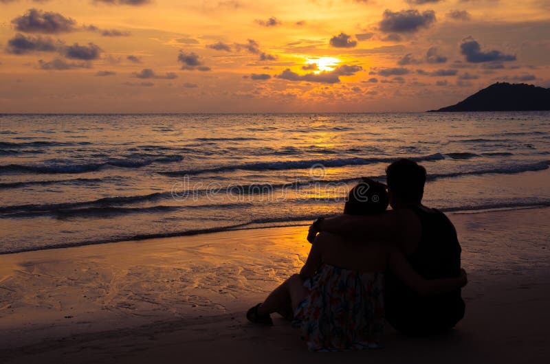Young Couple Sitting on Beach Stock Photo - Image of landscape, holiday ...