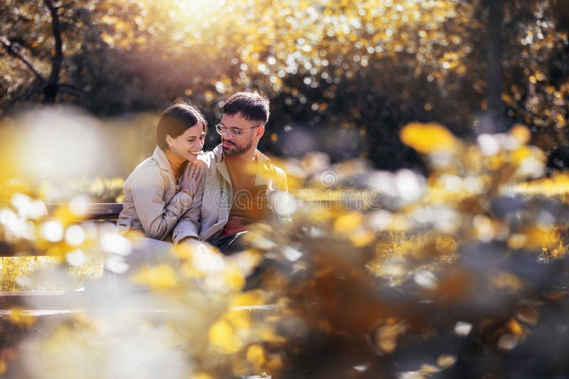 Couple Sitting on Bench in Park and Having Fun Stock Image - Image of ...