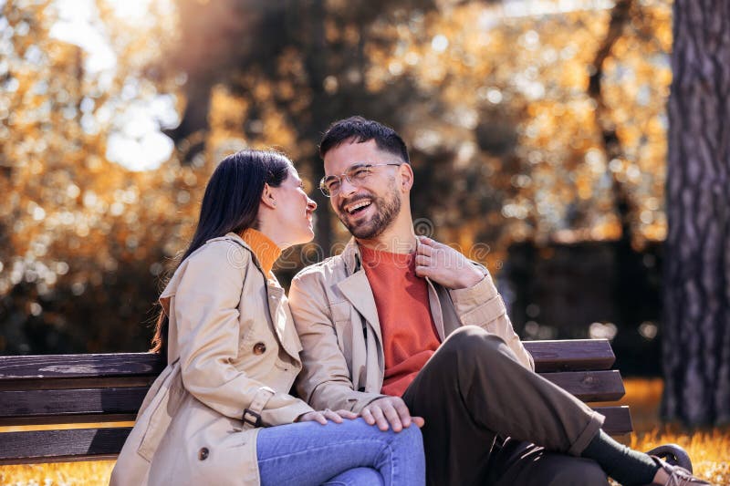 Couple Sitting on Bench in Park and Having Fun Stock Image - Image of ...