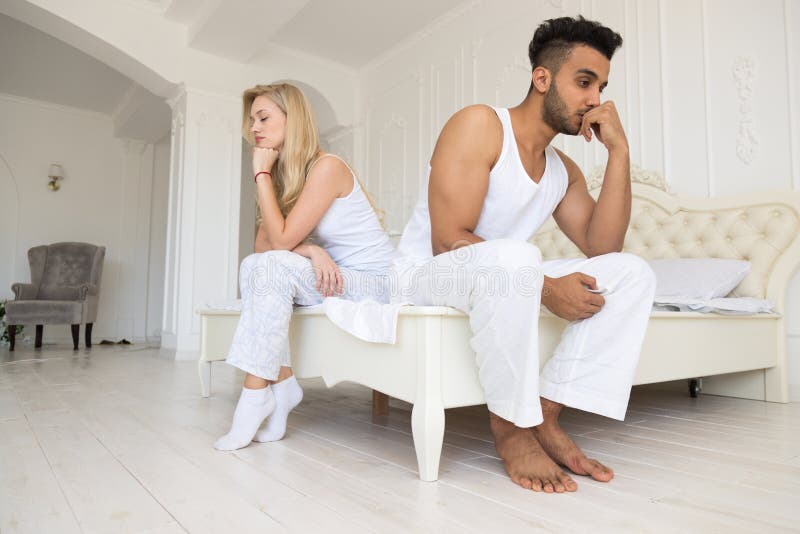 Young Couple Sitting Separate On Bed Having Conflict Relationships