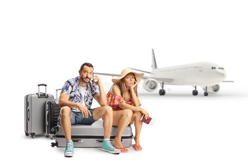 Young Couple Sitting on a Suitcase Using a Smartphone and Waiting for a ...