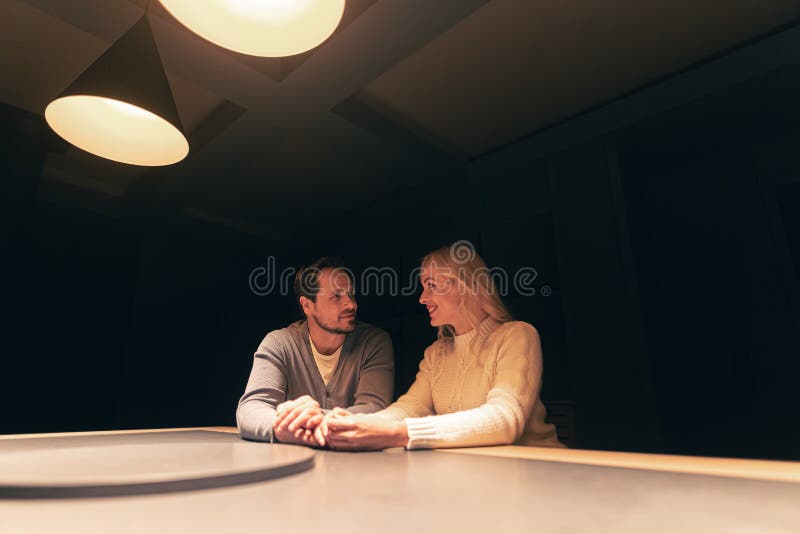 The Young Couple Sitting at the Table in Empty Night Bar. Stock Photo ...