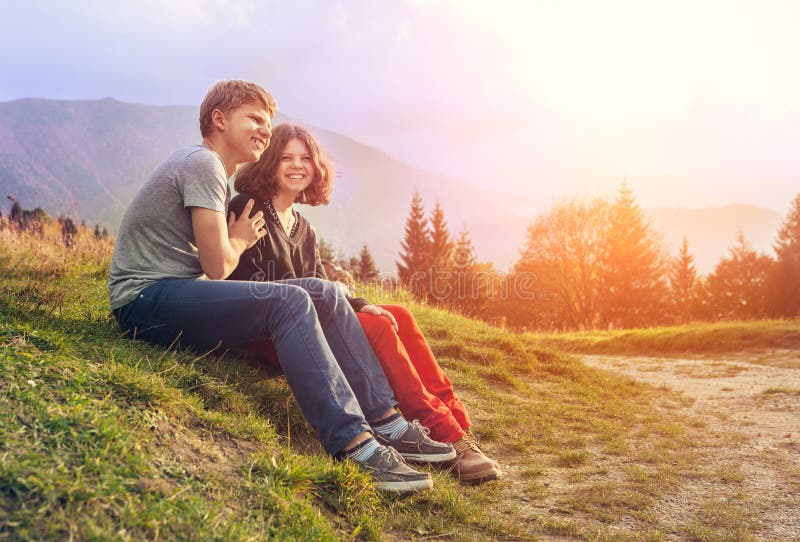 Young Couple Sitting Together at the Sunset Stock Photo - Image of ...