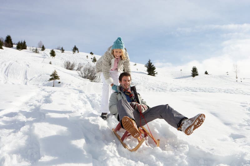 Young Couple Sledding stock image. Image of slope, male - 20118059
