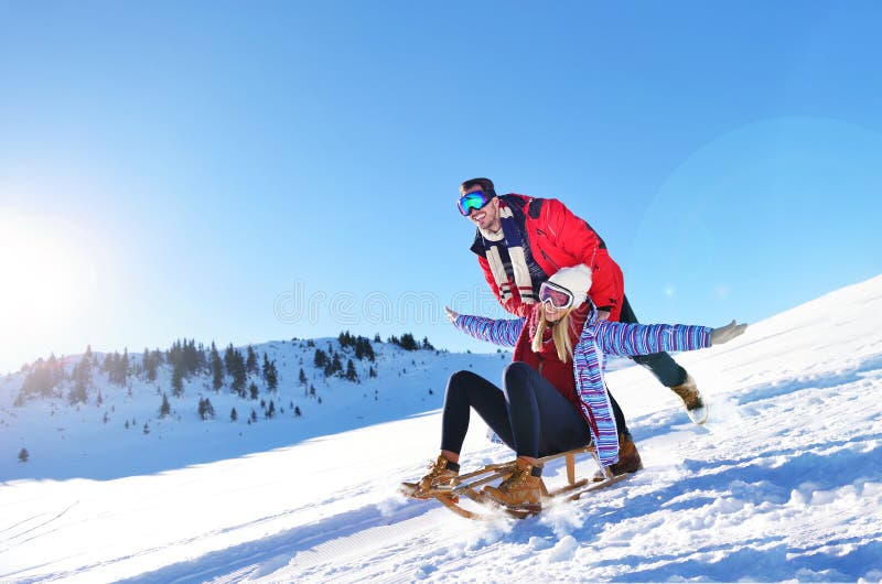 Young Couple Sledding and Enjoying on Sunny Winter Day Stock Photo ...