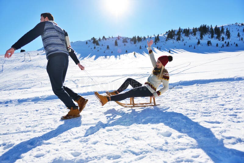 Young Couple Sledding and Enjoying on Sunny Winter Day Stock Image ...