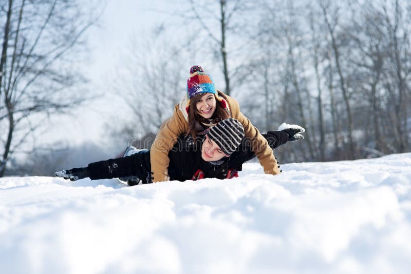Young Couple Sledding on Snow Stock Photo - Image of love ...